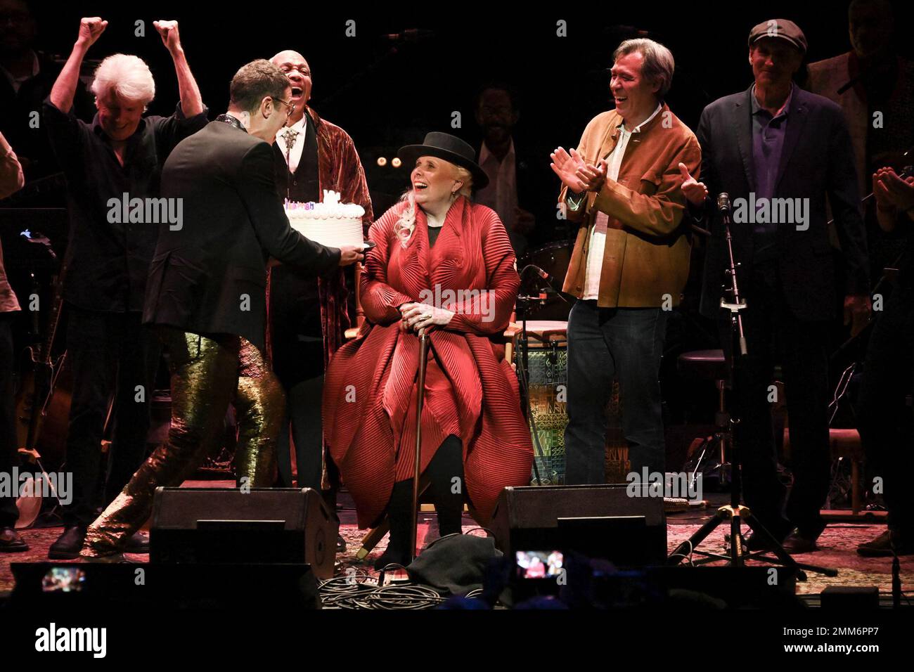 Joni Mitchell is presented with a birthday cake on stage at JONI 75: A ...