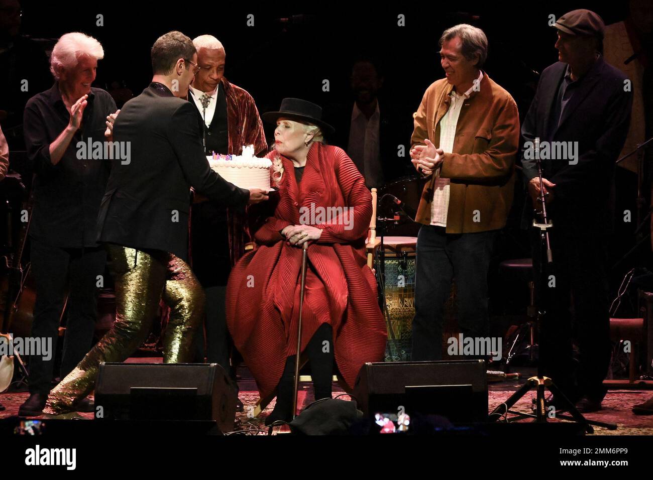 Joni Mitchell is presented with a birthday cake on stage at JONI 75: A ...