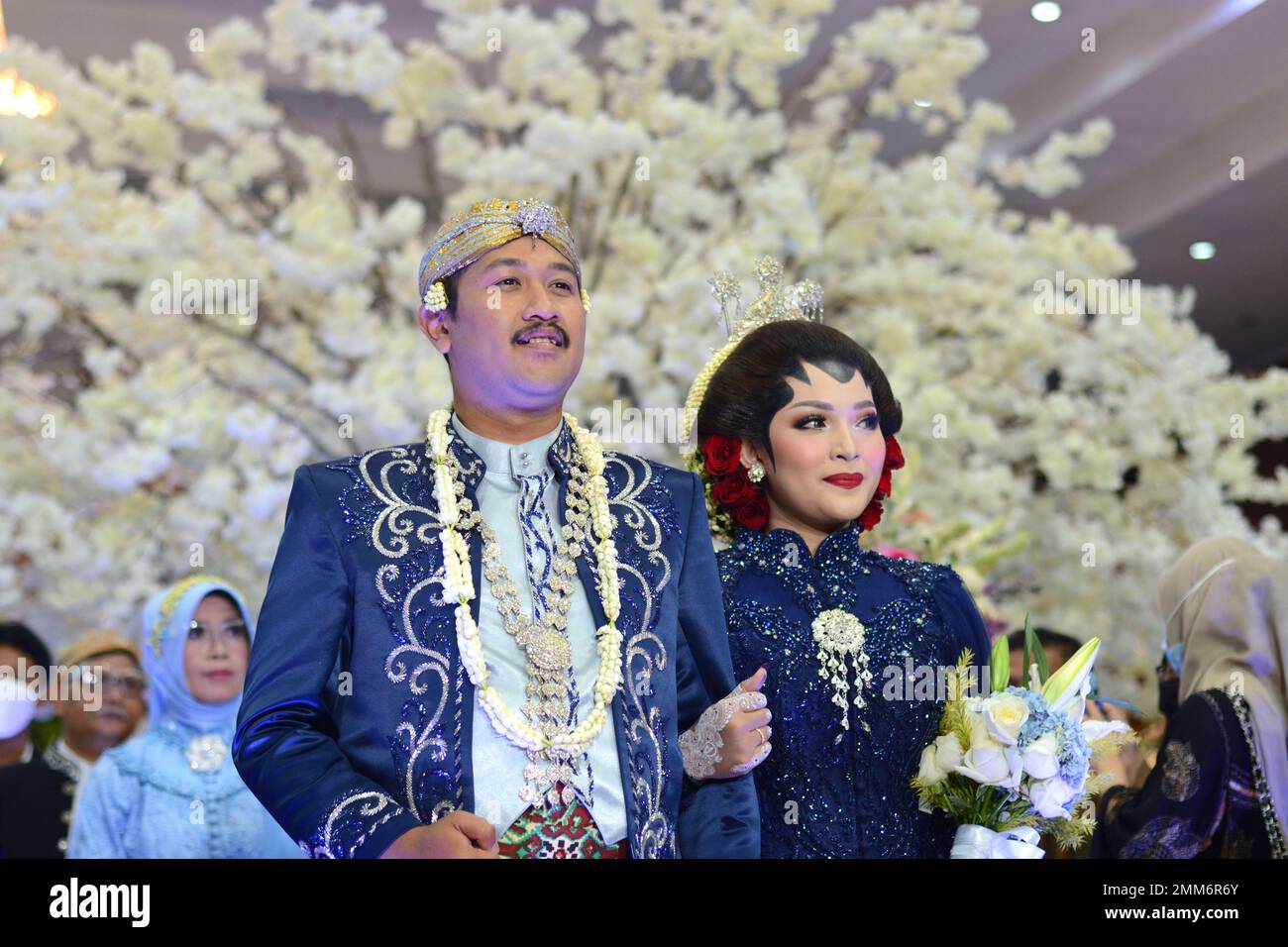 a wedding procession with Javanese tradition. The bride wears ...