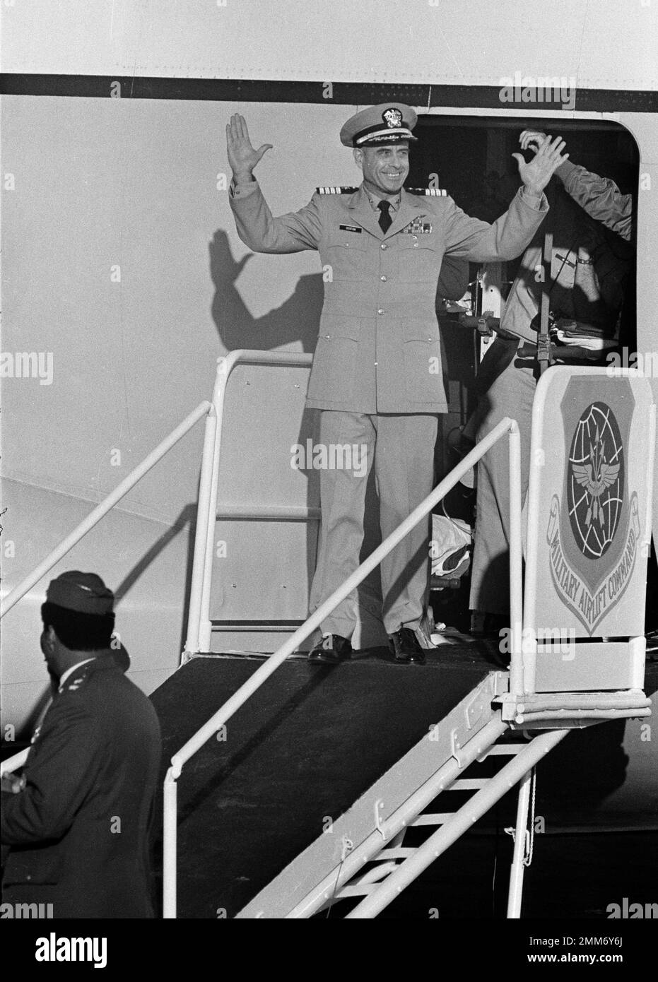 U.S. Navy Captain Jeremiah Denton Jr. throws both arms in the air as he ...