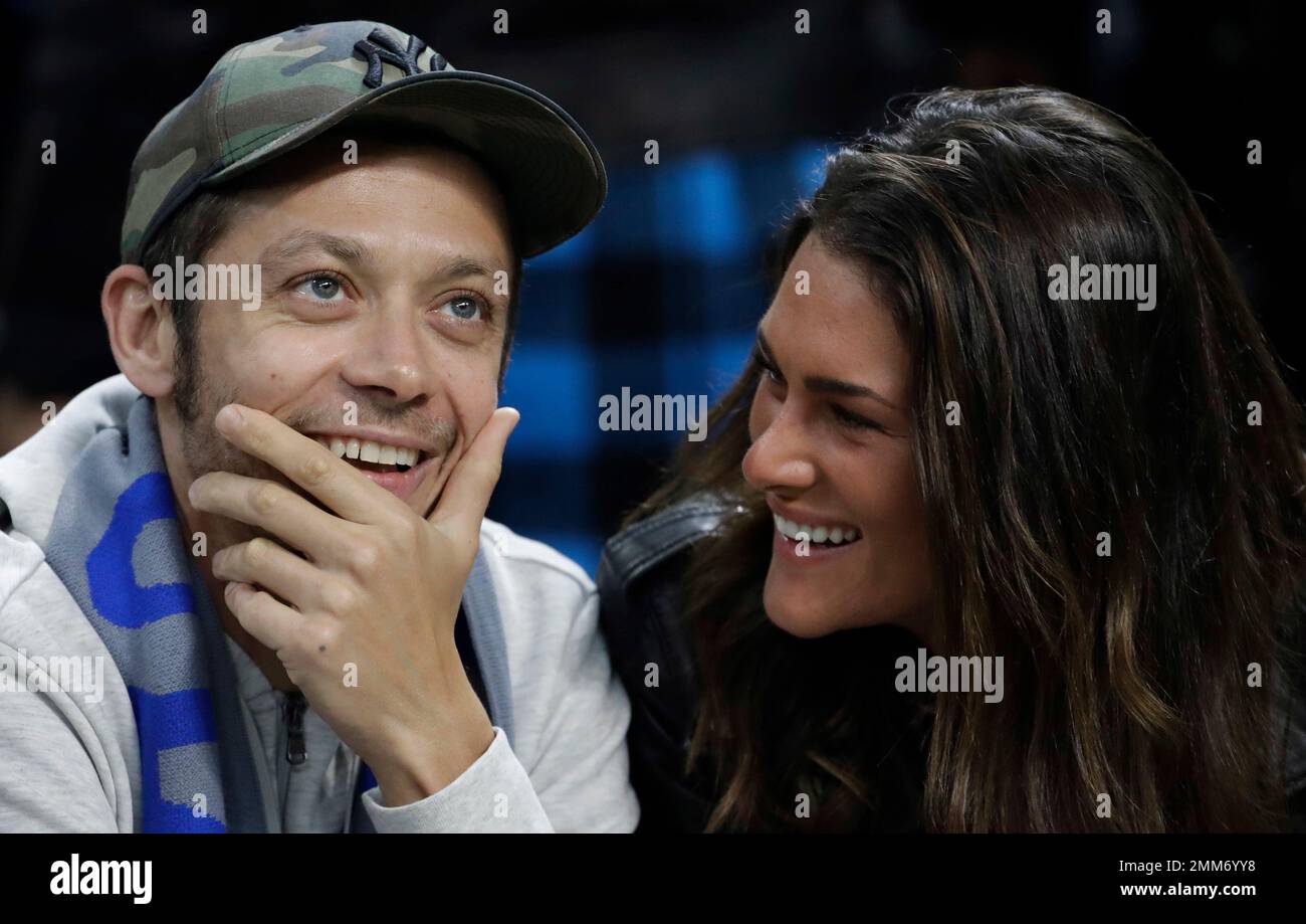 Yamaha rider Valentino Rossi of Italy is flanked by his partner ...
