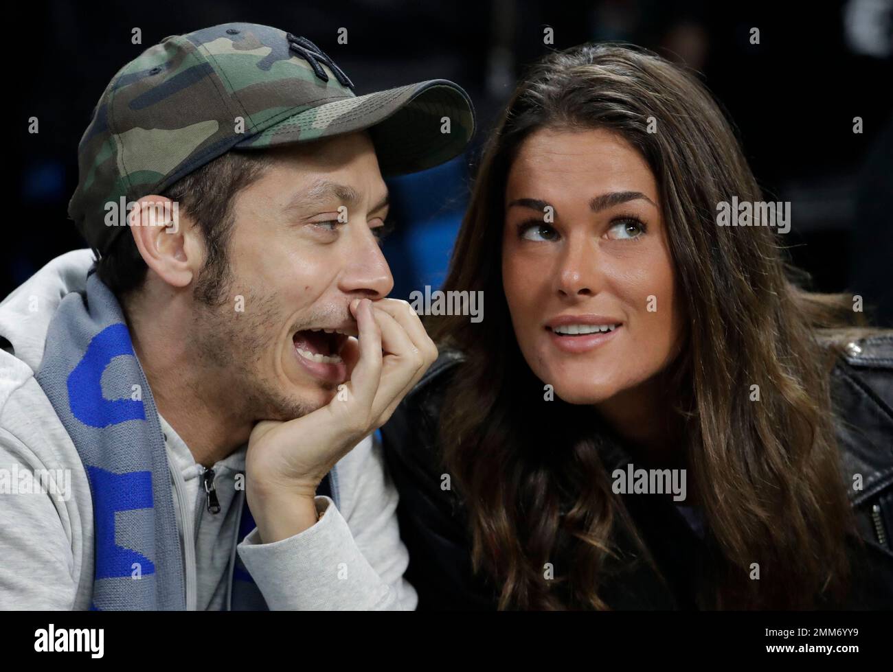 Yamaha rider Valentino Rossi of Italy is flanked by his partner ...