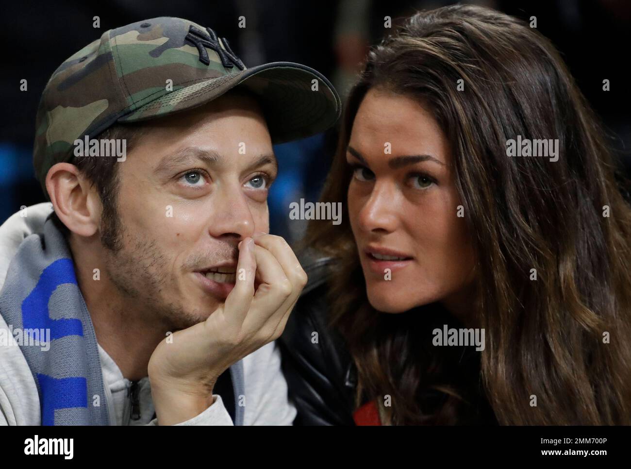 Yamaha rider Valentino Rossi of Italy is flanked by his partner ...