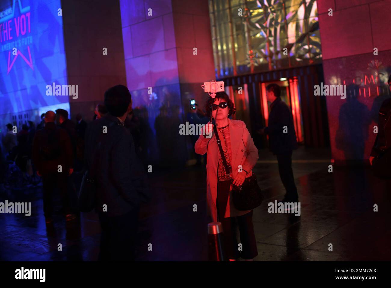 Tourists take photos of the famed 30 Rockefeller Plaza building ...