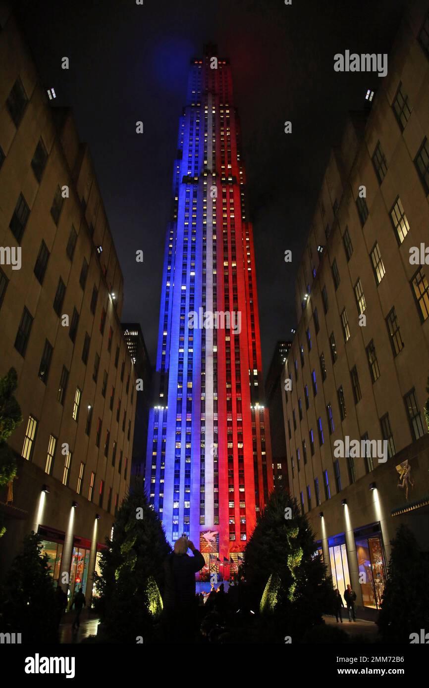 Tourists take photos of the famed 30 Rockefeller Plaza building ...