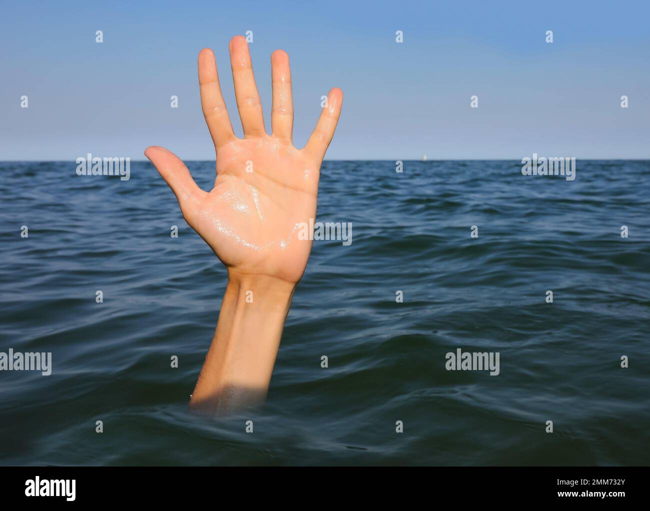 Open hand with five fingers of the person who is drowning in the sea ...