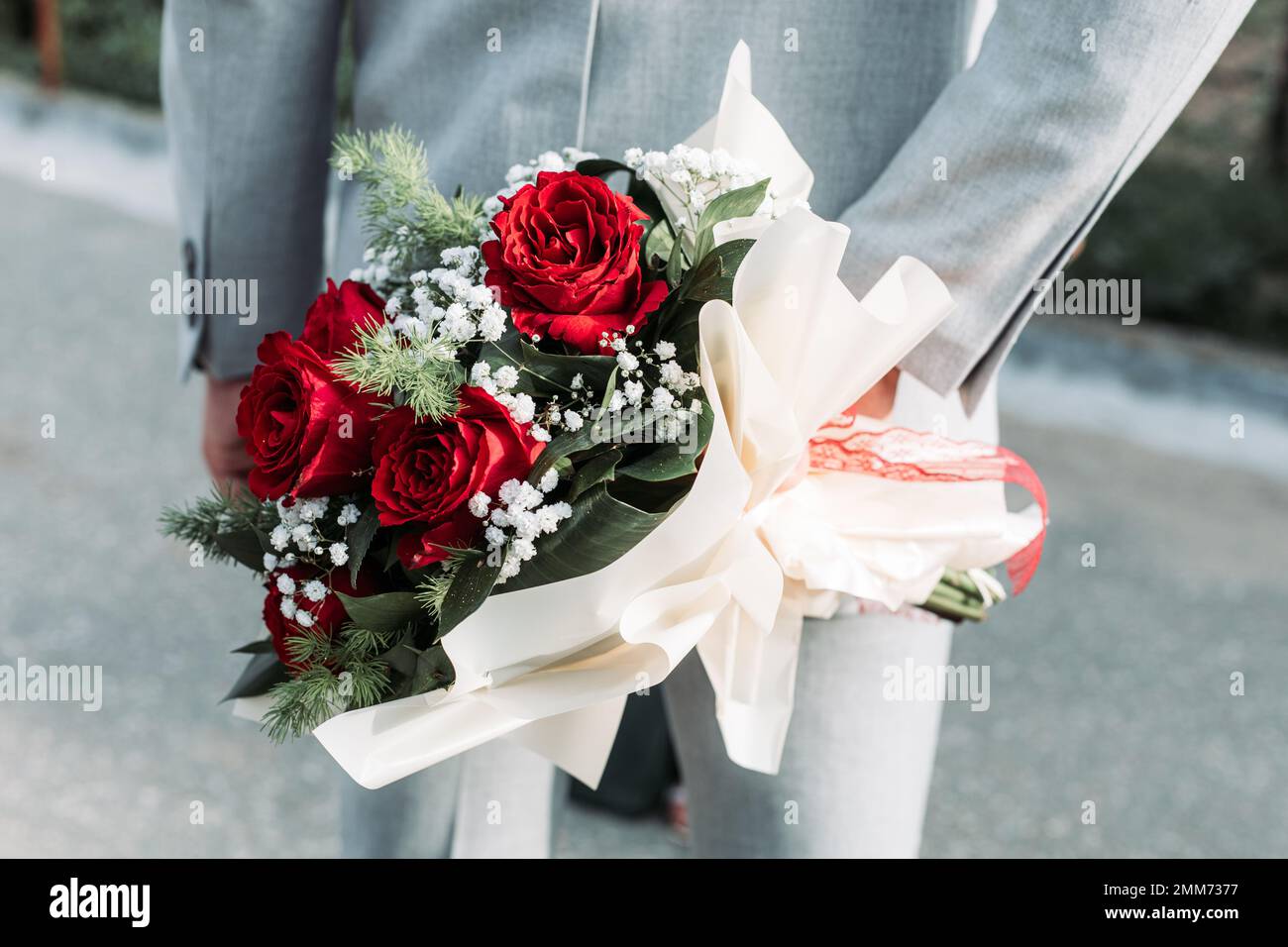 Husband hiding flower behind back hi-res stock photography and images ...
