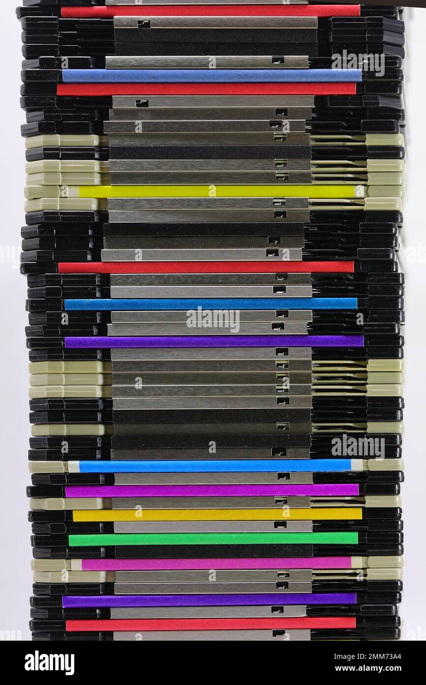 stack of many old magnetic floppy disks used to save data from the ...