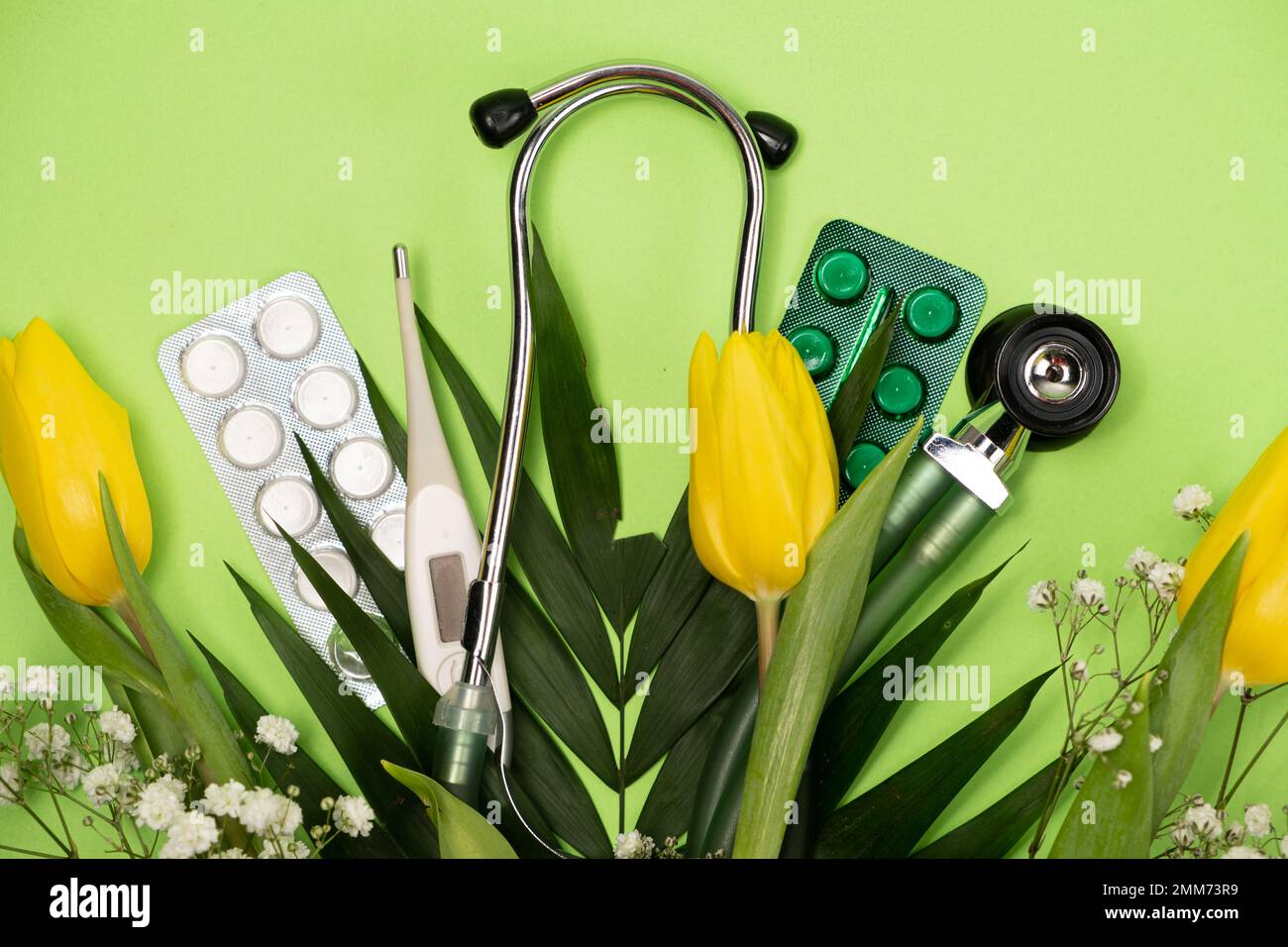 Bouquet of flowers and stethoscope on a green background, happy doctors ...