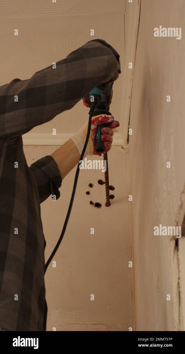 punching holes in the shape of a circle in the wall under the ceiling ...