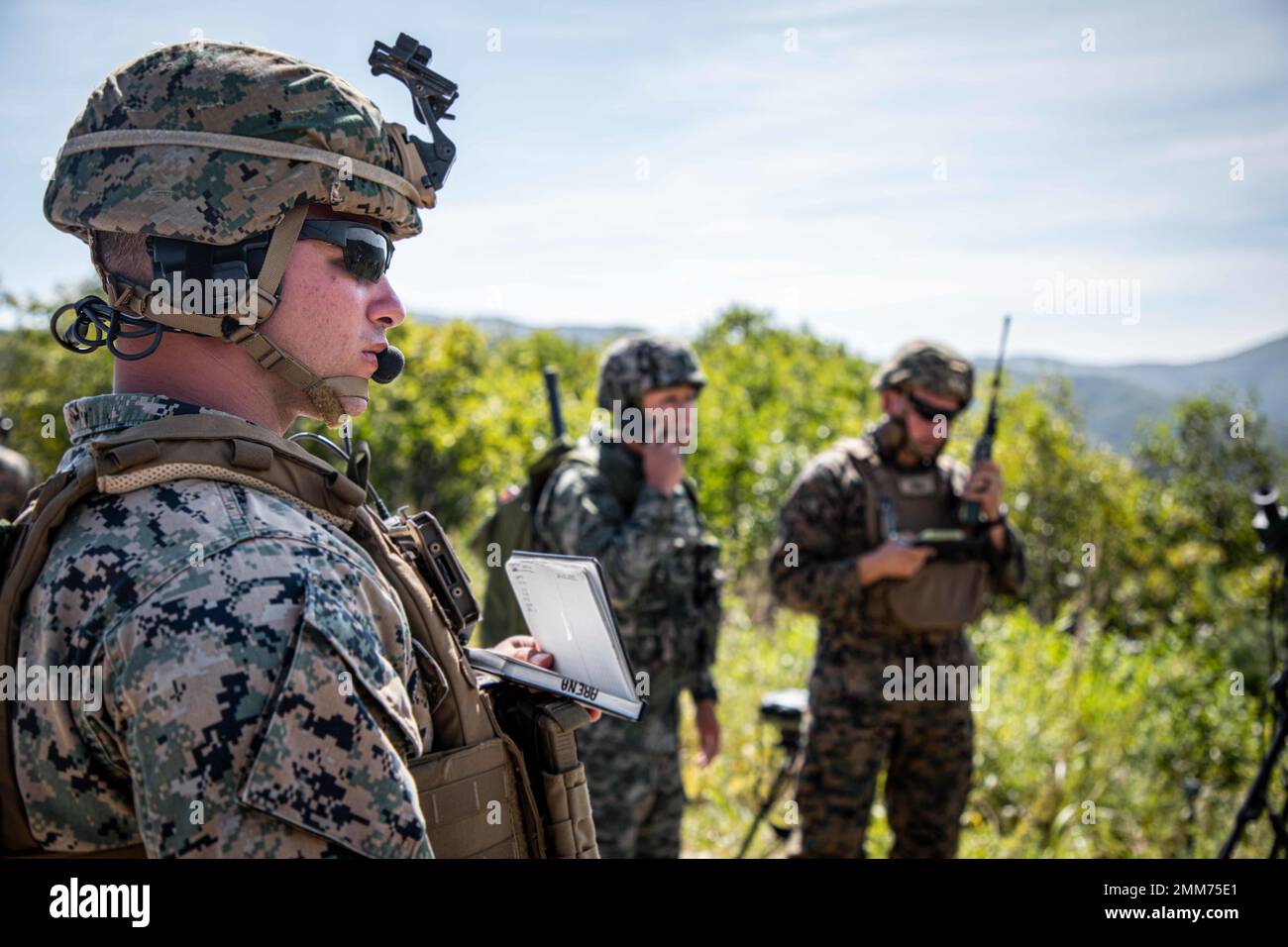 U.S. Marine Corps Capt. Shane Arena, a fire support coordinator (center ...