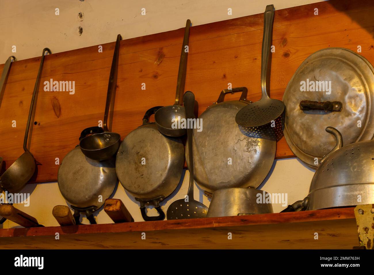 series of pots and pans in aluminum and metal ladles from an ancient ...