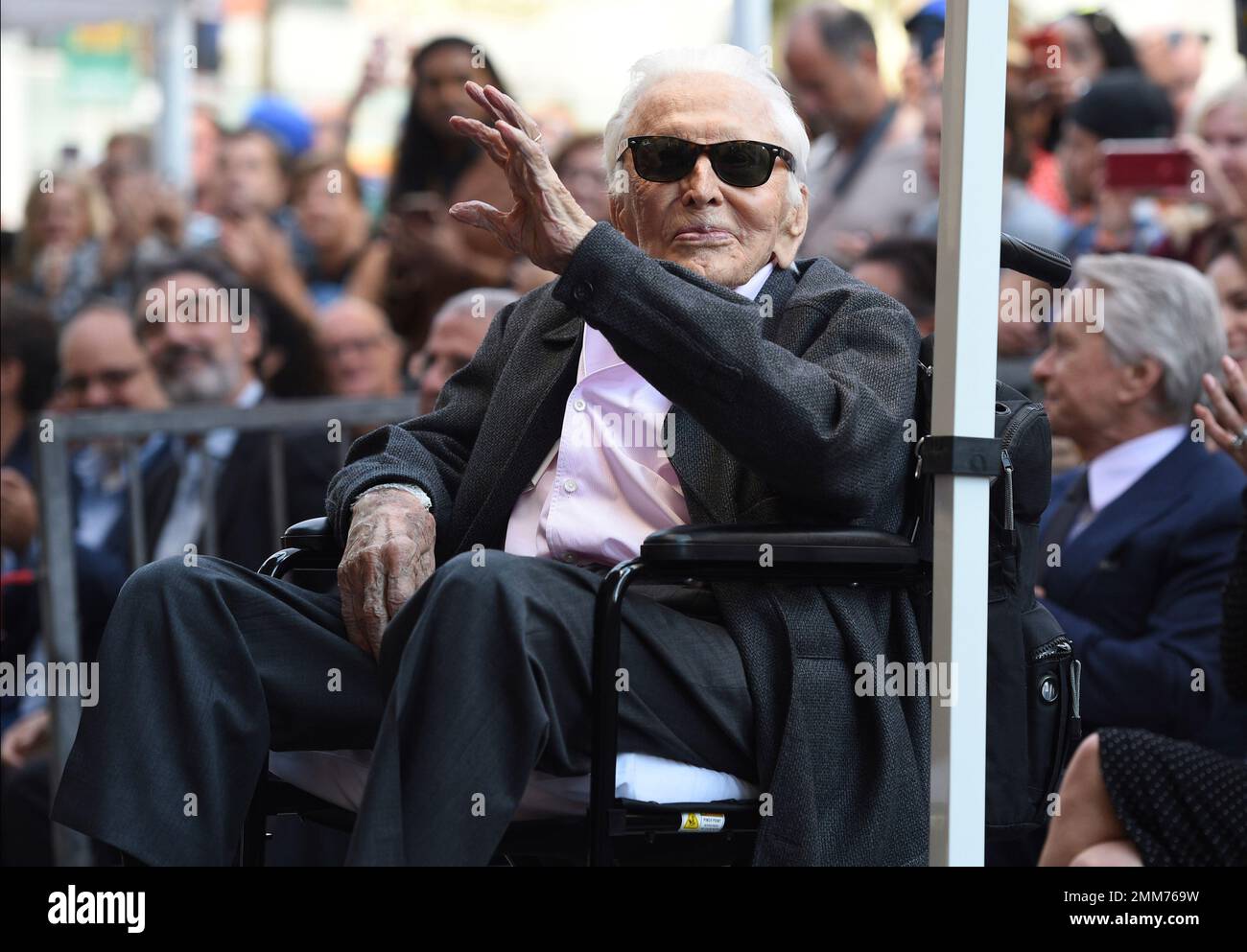 Actor Kirk Douglas waves to the crowd during a ceremony honoring his ...