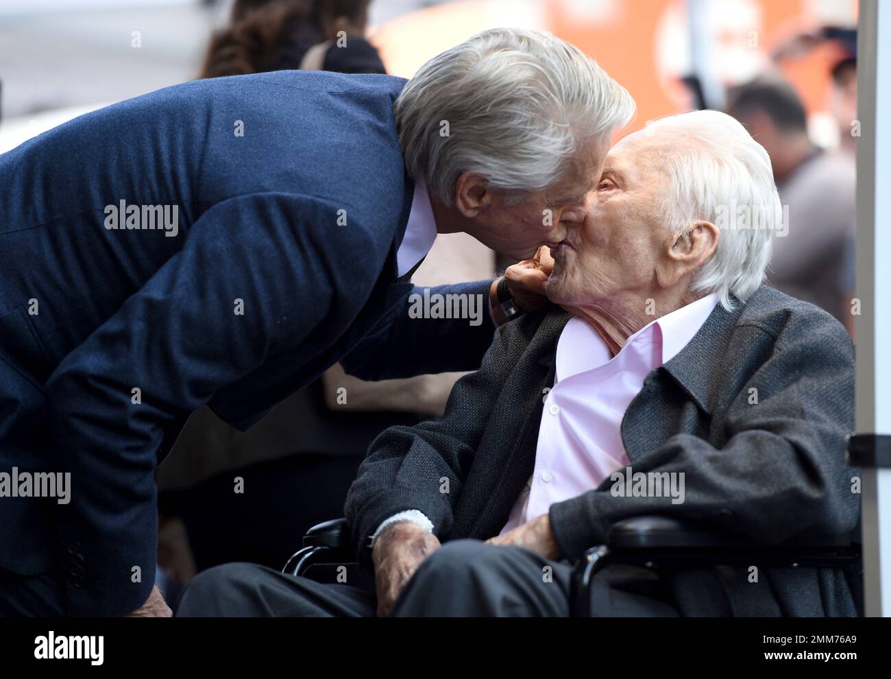 Honoree Michael Douglas, left, kisses his father Kirk Douglas before a Hollywood Walk of Fame ...
