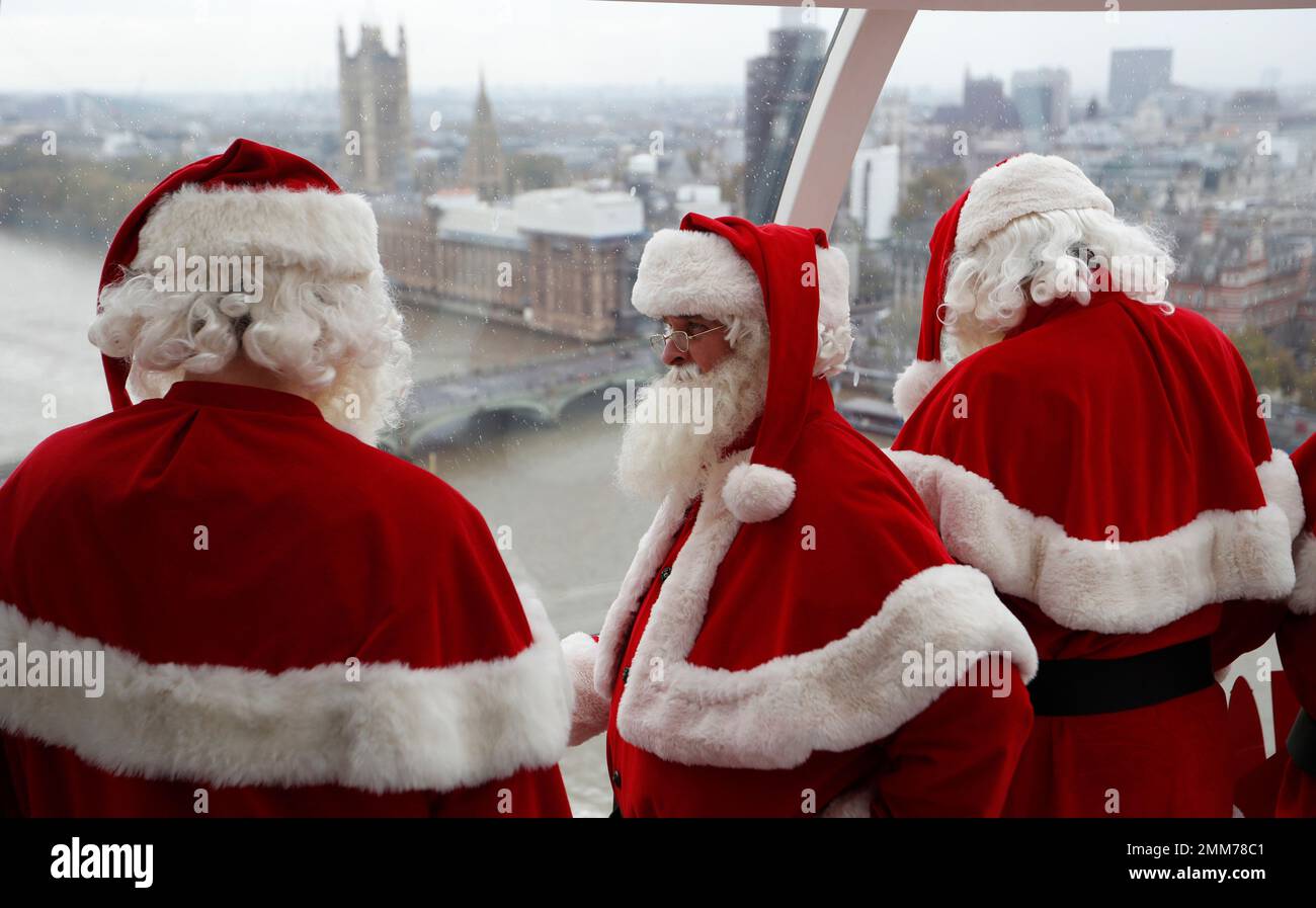 Santas from the Santa School take a look at the London skyline from a ...