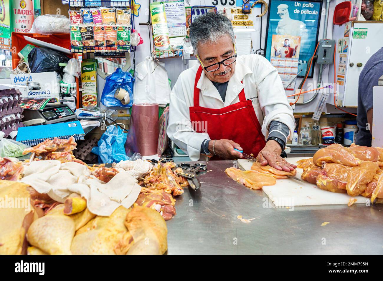 Mexico City,Mercado Medellin,butcher raw chicken cutting,man men male ...