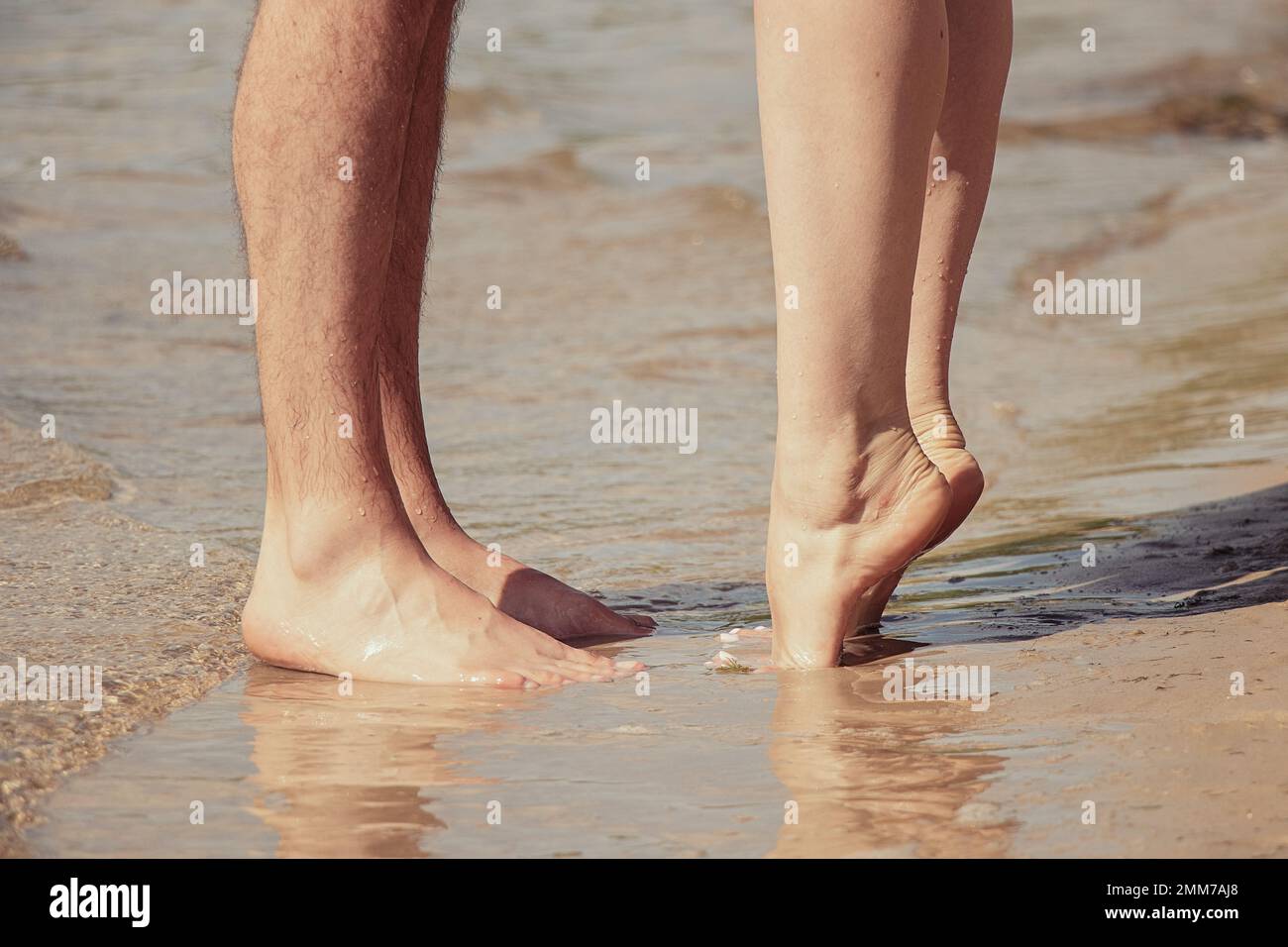 male and female feet in sea water bottom view in the sun Stock Photo ...