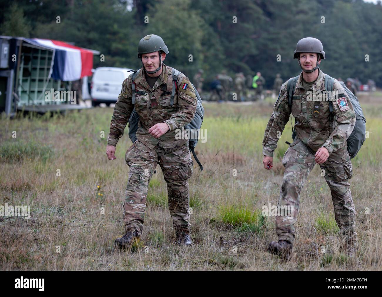 Two Dutch Paratroopers walk off the Drop Zone with their assigned ...