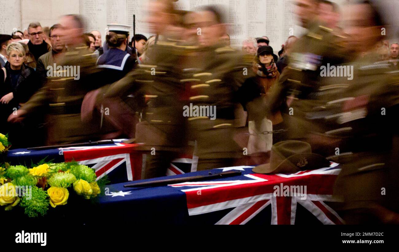 An Australian honor guard marches past the caskets of two unidentified ...