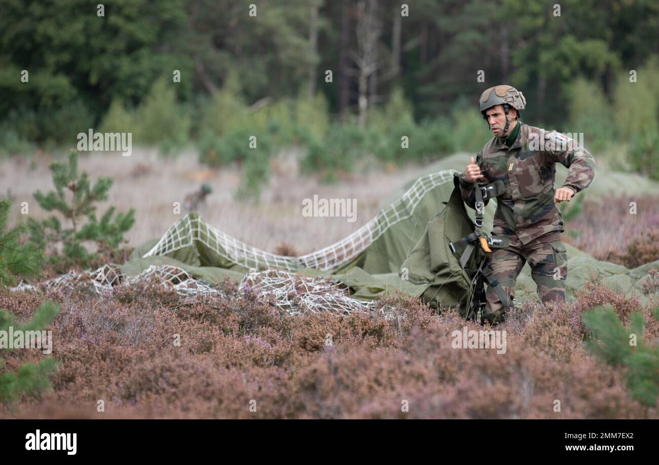 A French Paratrooper gathers up his assigned parachute during Exercise ...