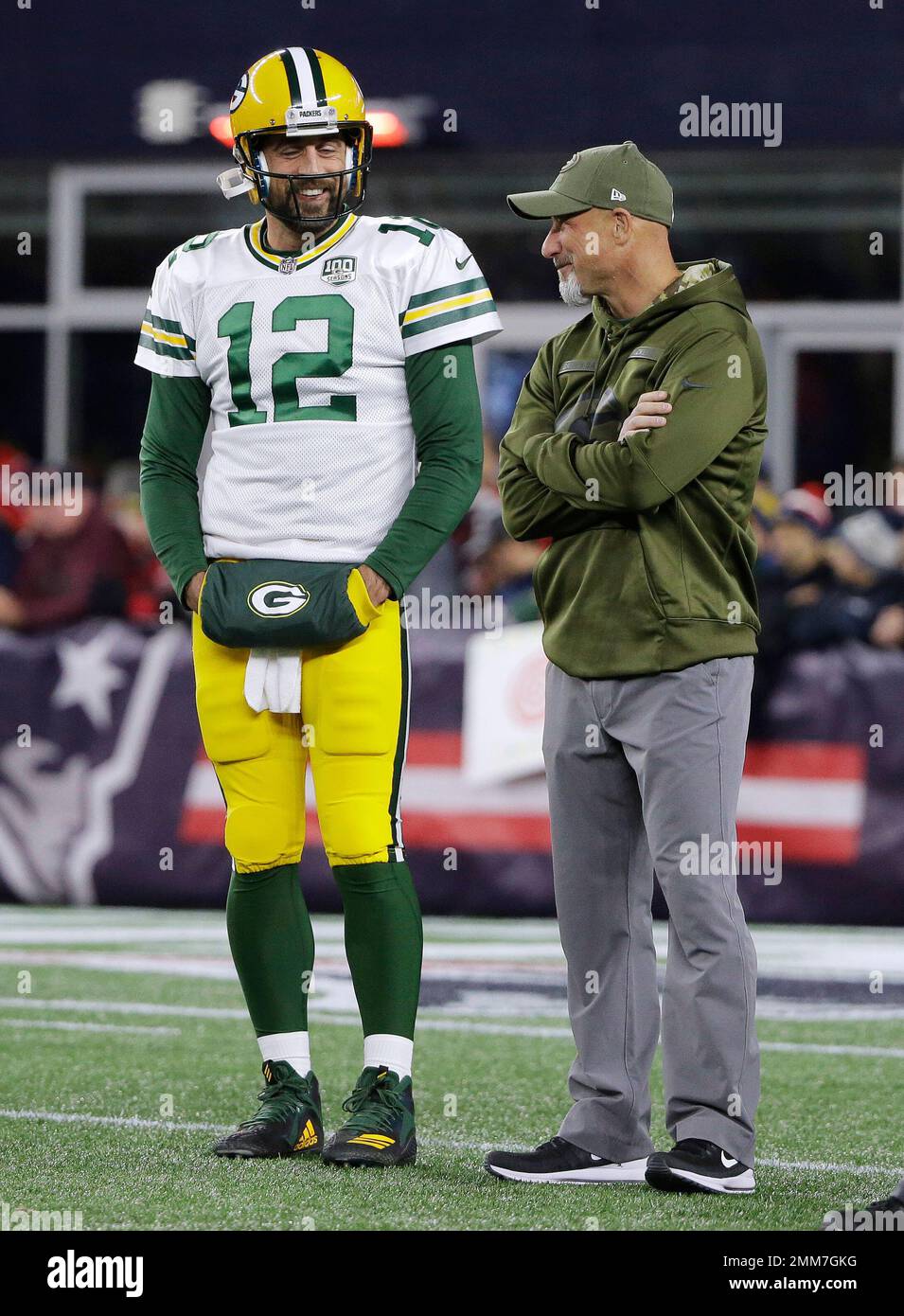 Green Bay Packers quarterback Aaron Rodgers, left, talks to coach Jim ...