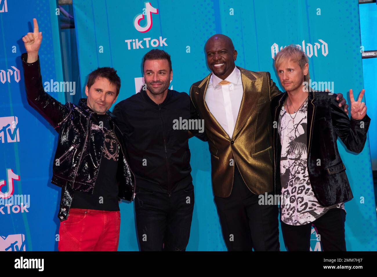 Members of music group Muse and actor Terry Crews pose for ...