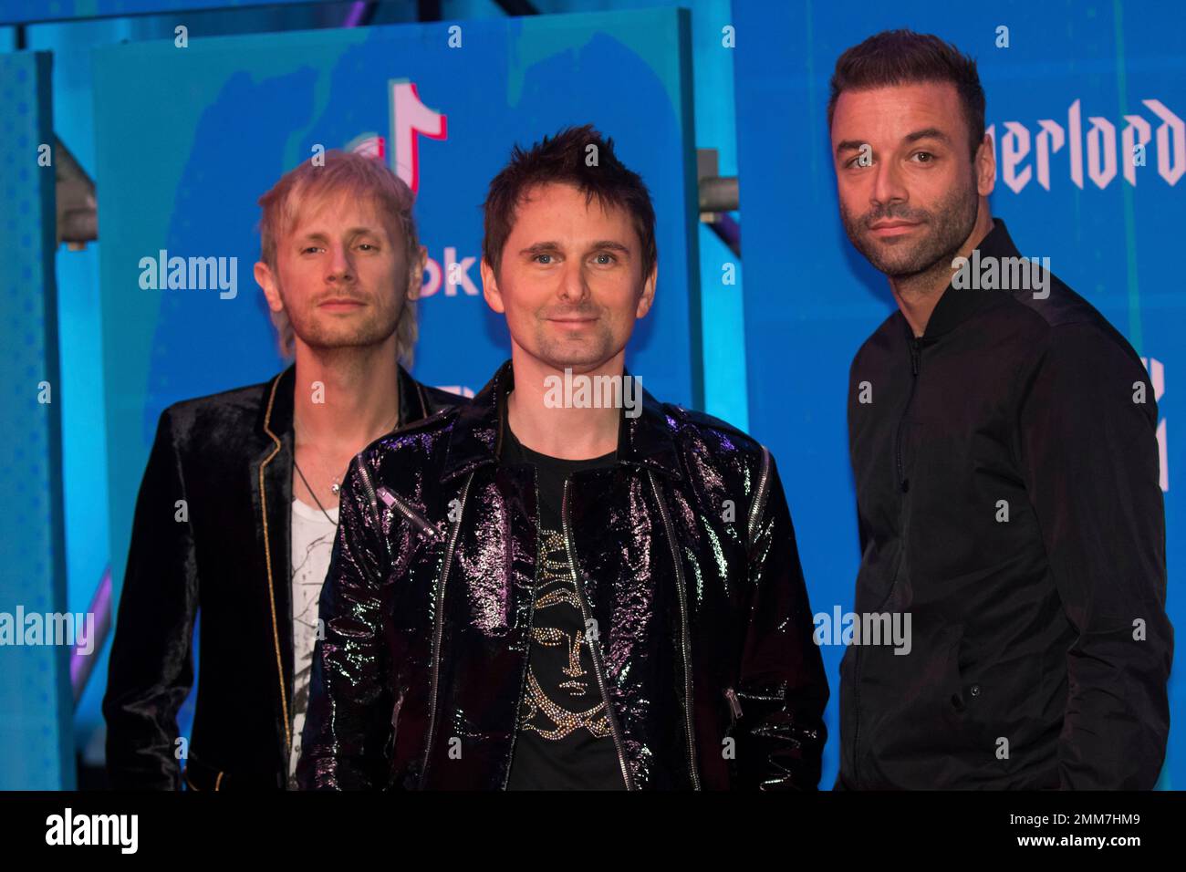Members of music band Muse, with singer Matt Bellamy in the center ...