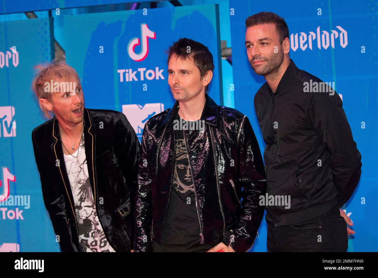 Members of music band Muse, with singer Matt Bellamy in the center ...