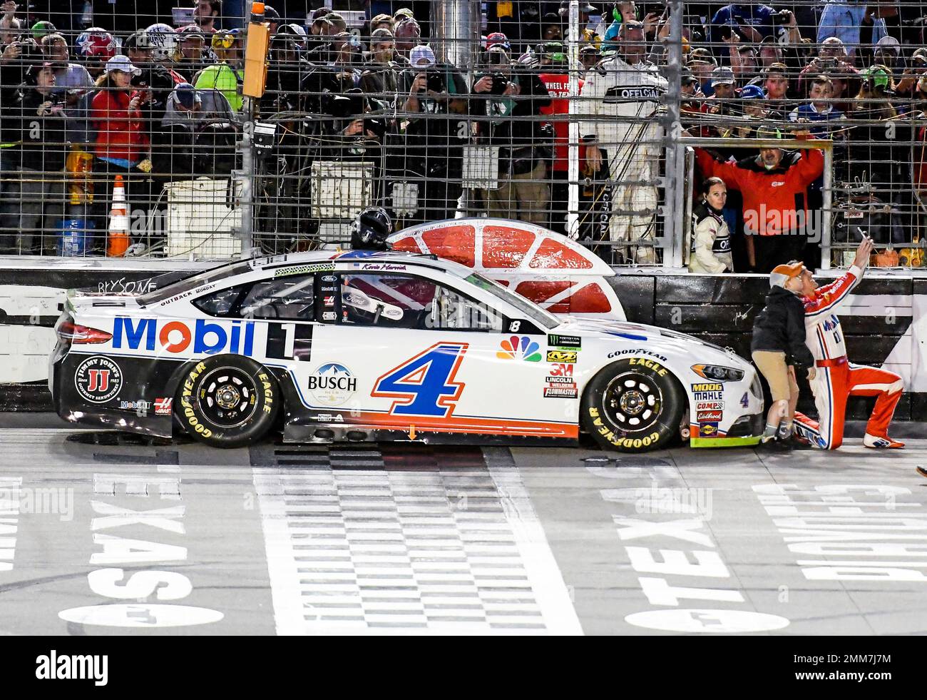 Kevin Harvick takes a photo with a young fan after winning a NASCAR Cup ...