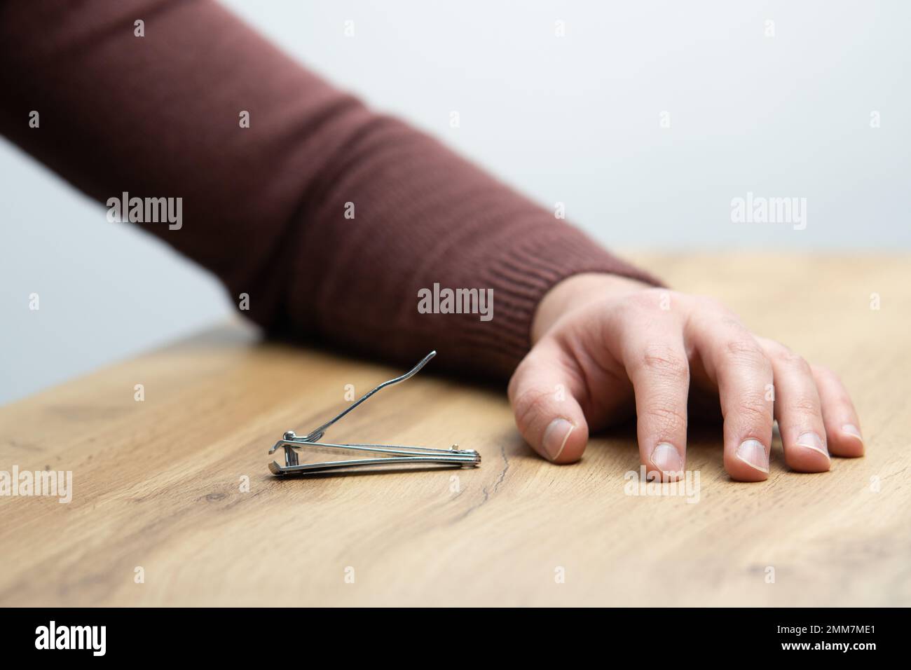 Close up of male hands cutting fingernails. Young handsome man clipping ...