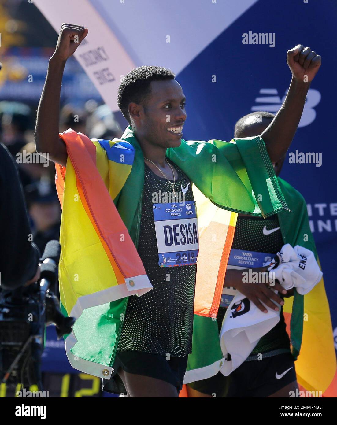 First place finisher Lelisa Desisa of Ethiopia reacts at the finish ...