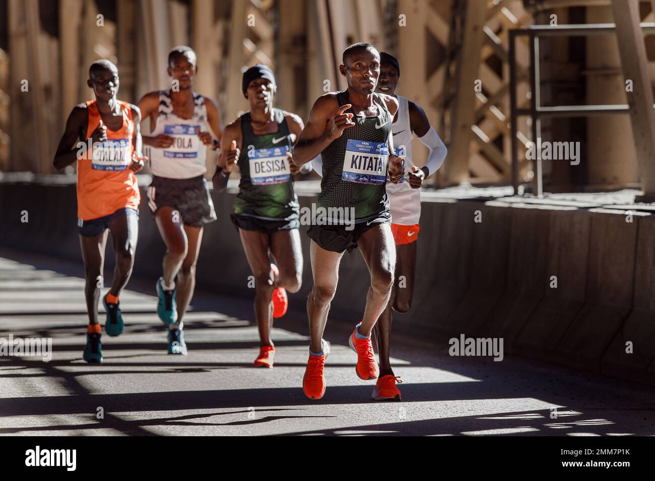 Tola Shura Kitata of Ethiopia, front, runs with the men's pack as they ...