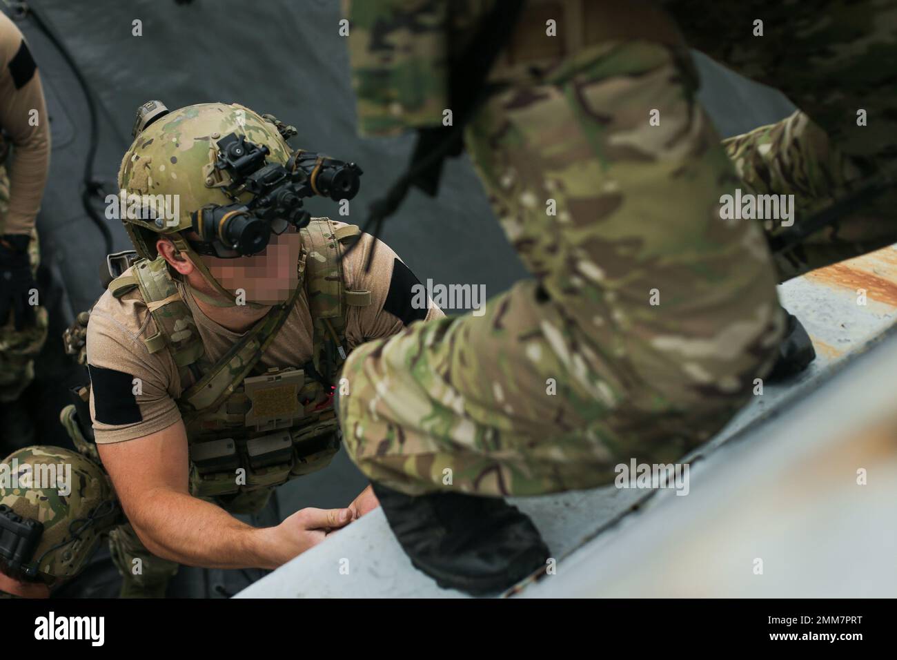 A U.S. Sailor assigned to a Navy SEAL Team, climbs up a ladder during ...