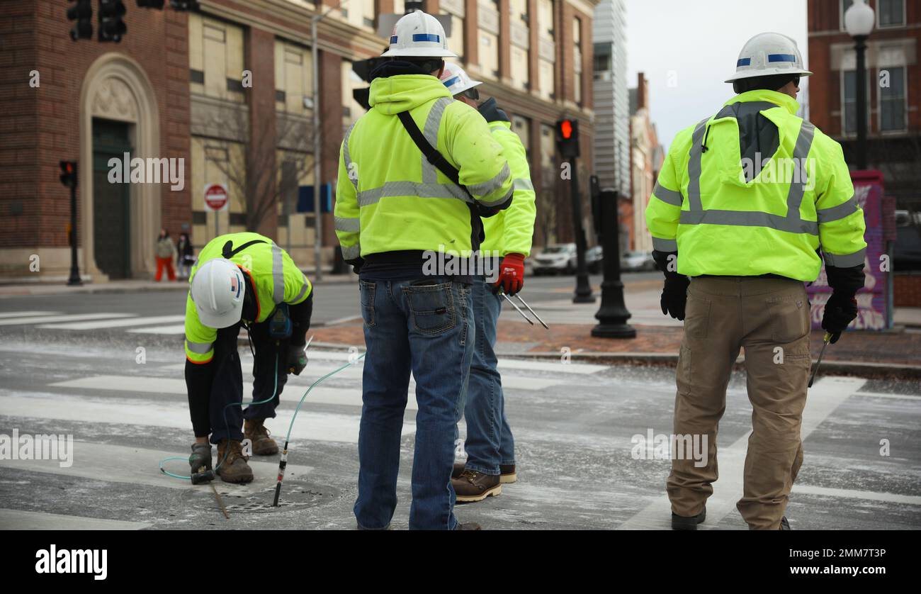 Construction Workers working at construction site yellow jacket helmet ...