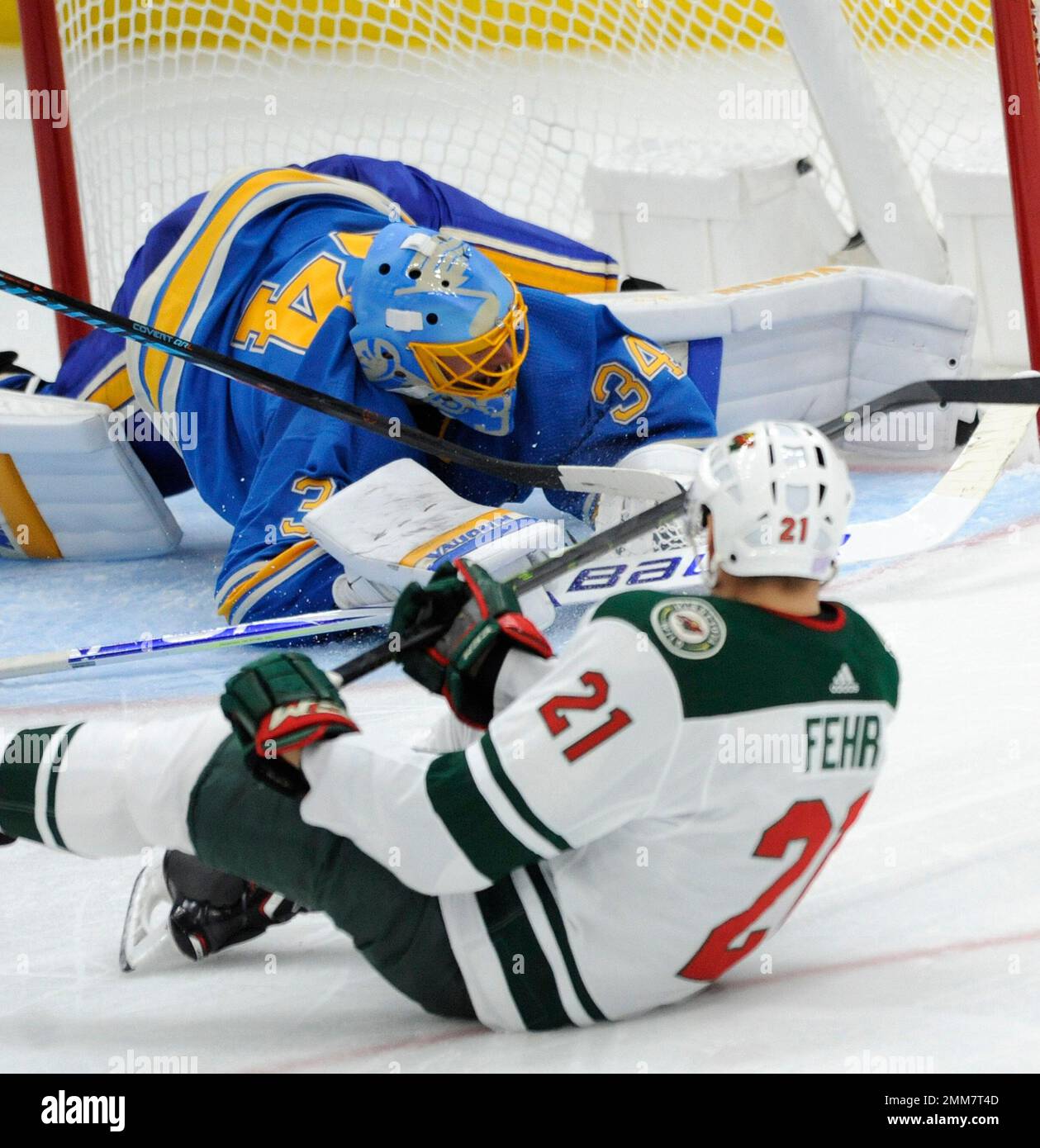 Minnesota Wild's Eric Fehr (21) scores against St. Louis Blues' Jake ...