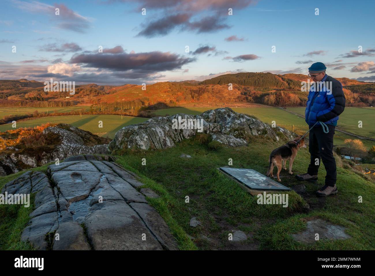 Person reading historical information near the summit of Dunadd hill ...