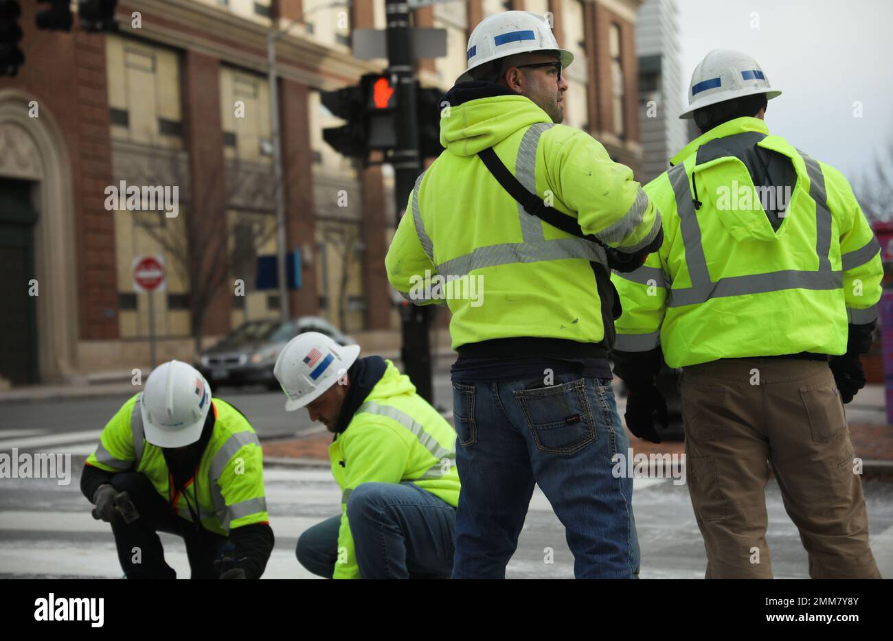 Construction Workers working at construction site yellow jacket helmet ...