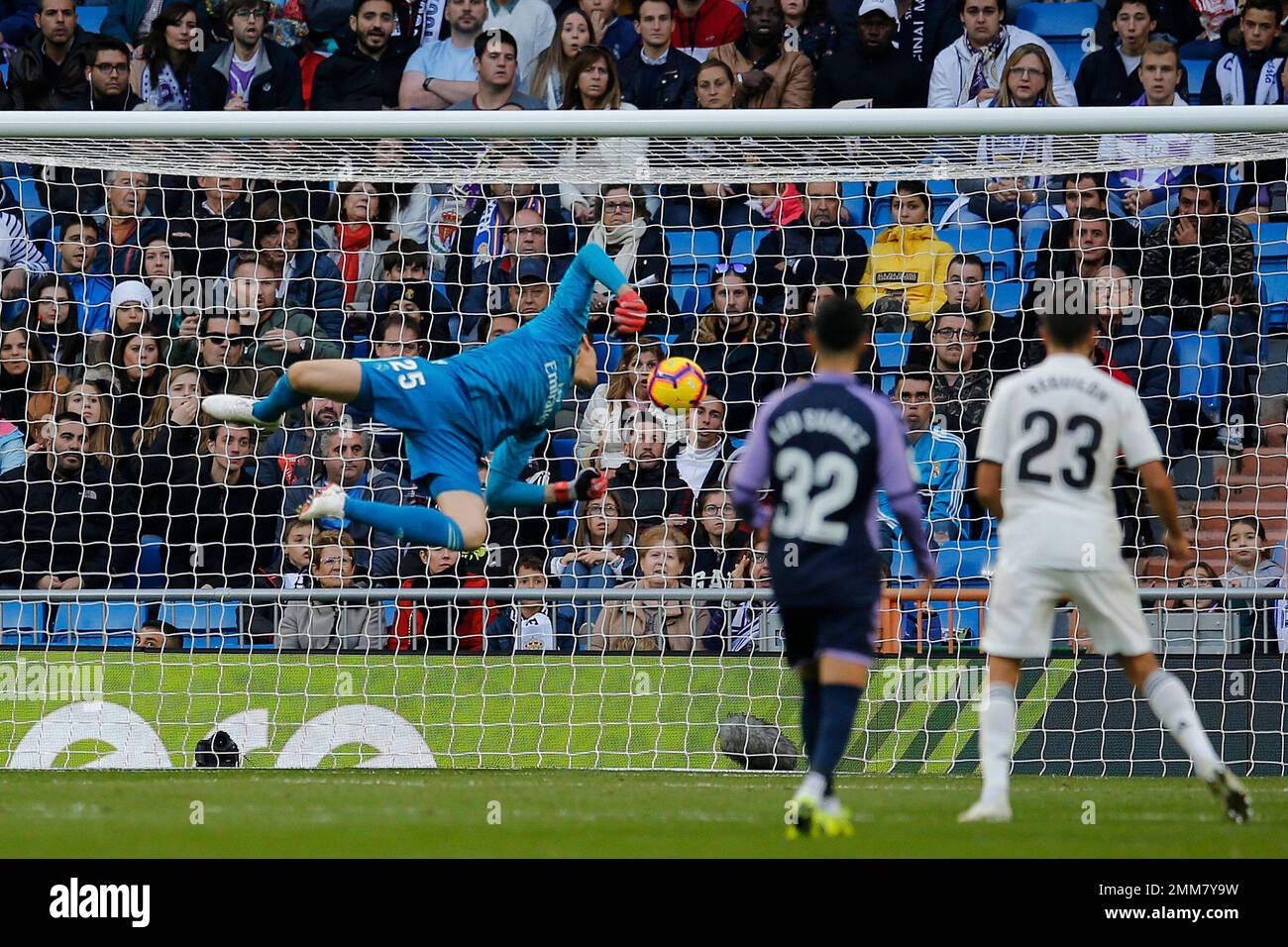 Real Madrid's goalkeeper Thibaut Courtois dives to save a shot during a ...