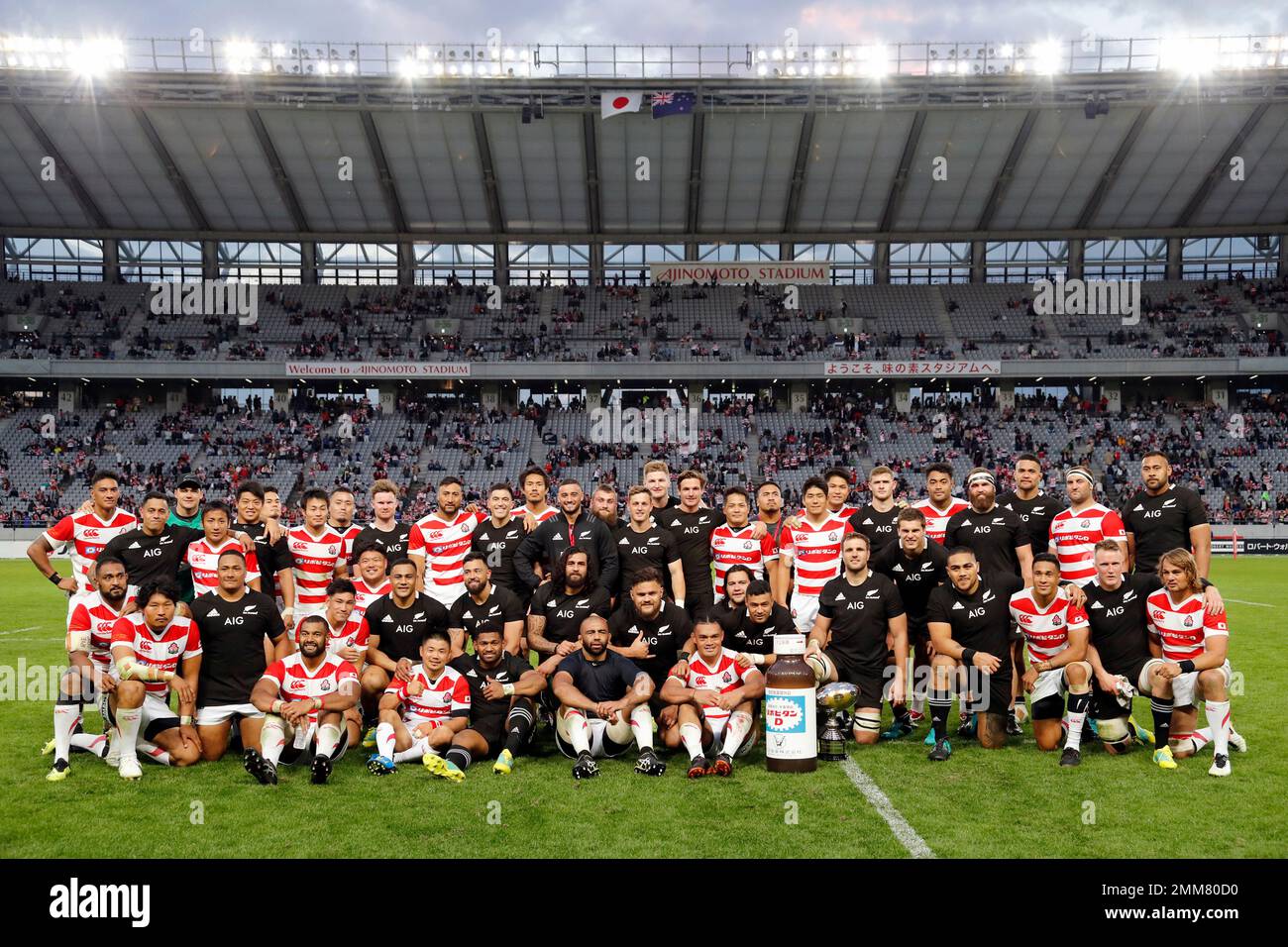 New Zealand's and Japan's players pose for a group photo after their ...