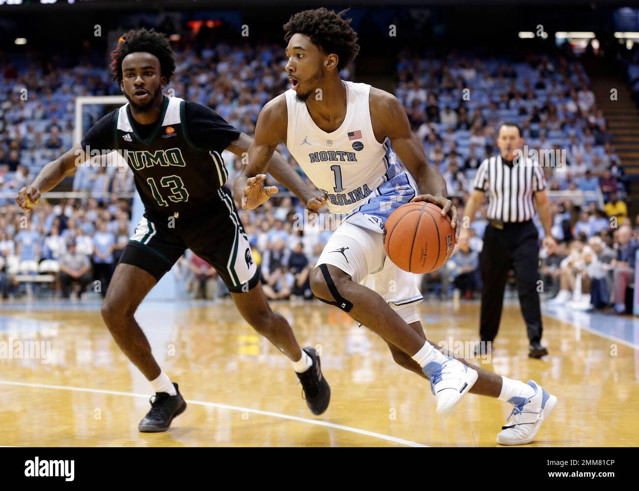 North Carolina's Leaky Black (1) dribbles while Mount Olive's Darius ...