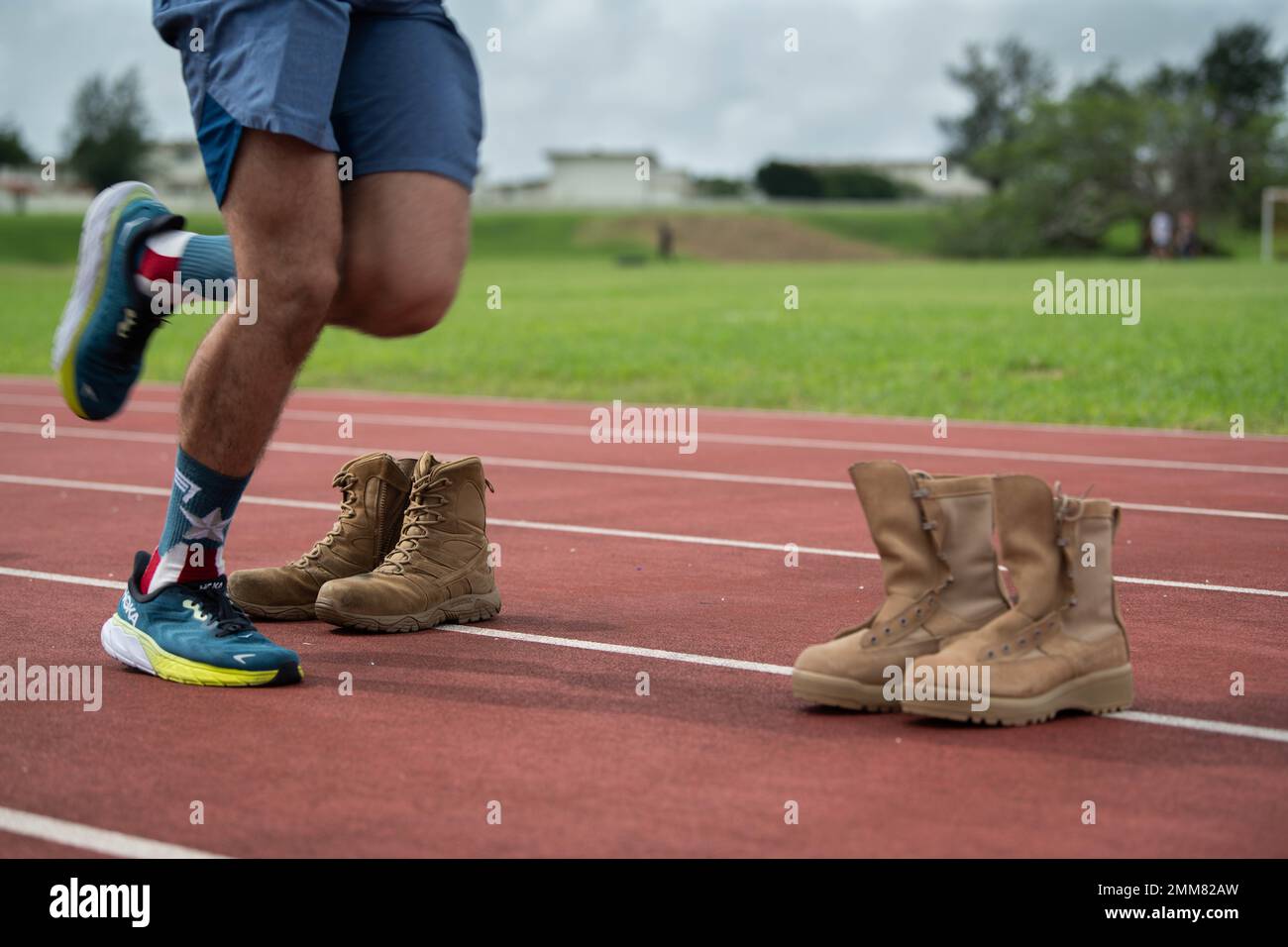 A participant runs past empty boots during the POW/MIA run at Kadena ...