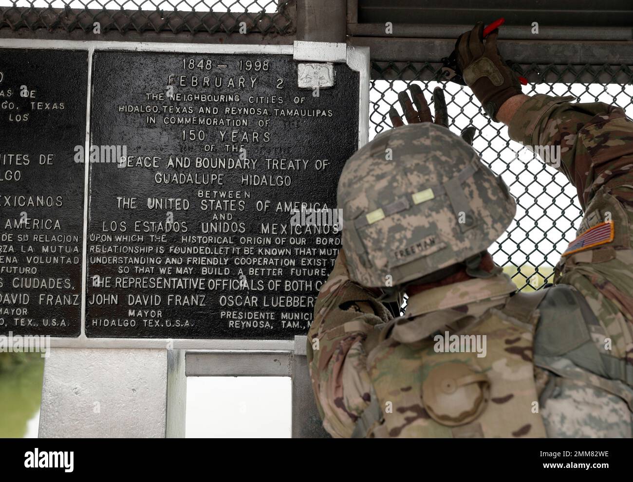 A member of the U.S.military cuts fencing at the U.S.-Mexico border on ...