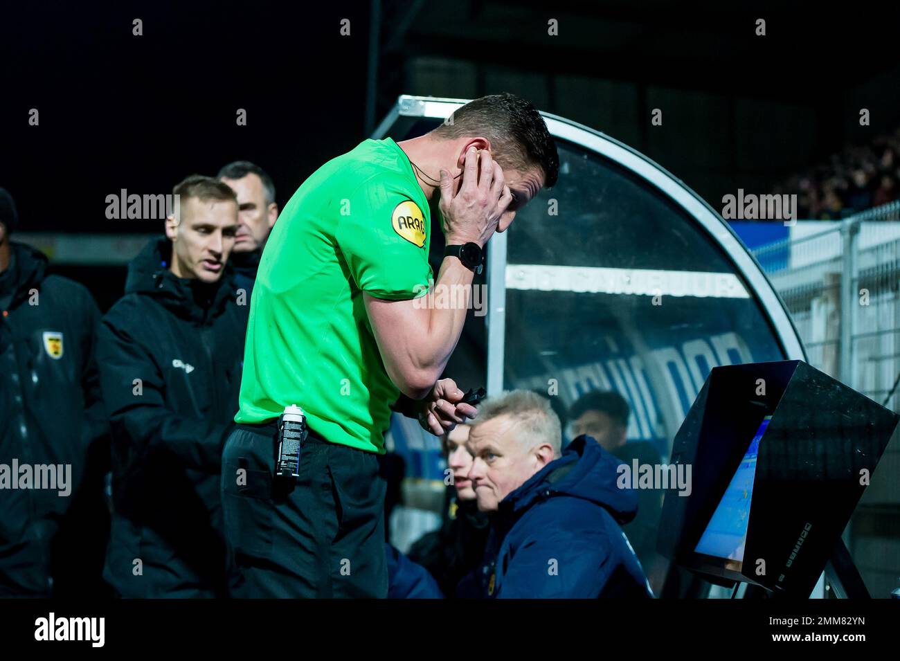 LEEUWARDEN - referee Jeroen Manschot reviews the VAR images to see if a ...