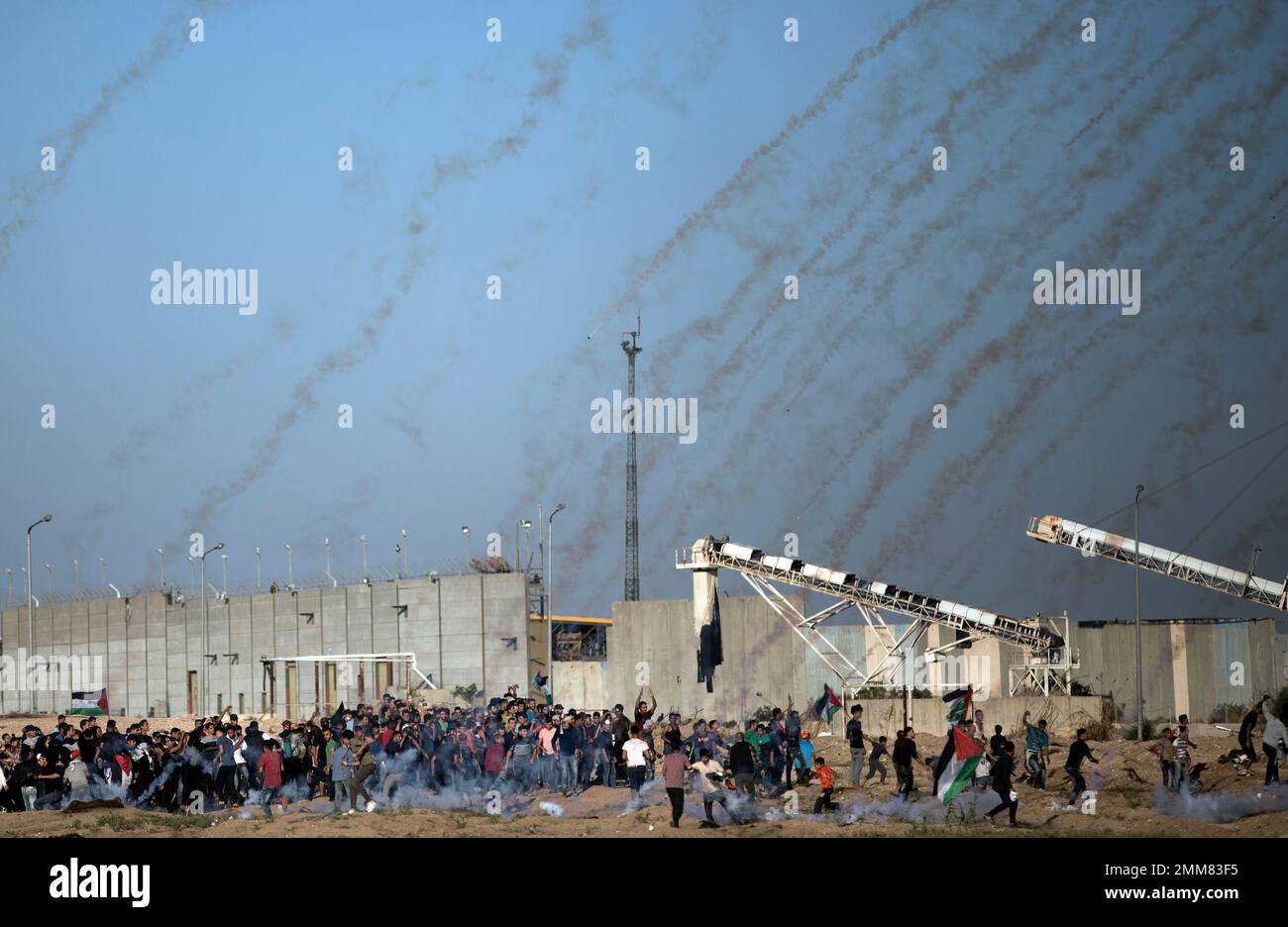 Teargas canisters fired by Israeli troops fall over Palestinians ...