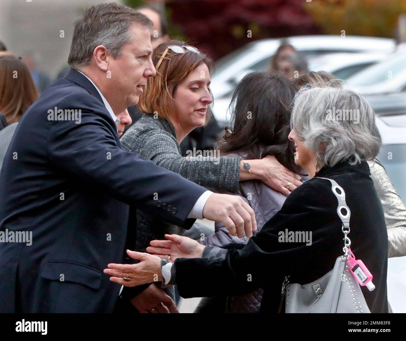 Visitors reach for each other as they gather for the funeral of Rose ...