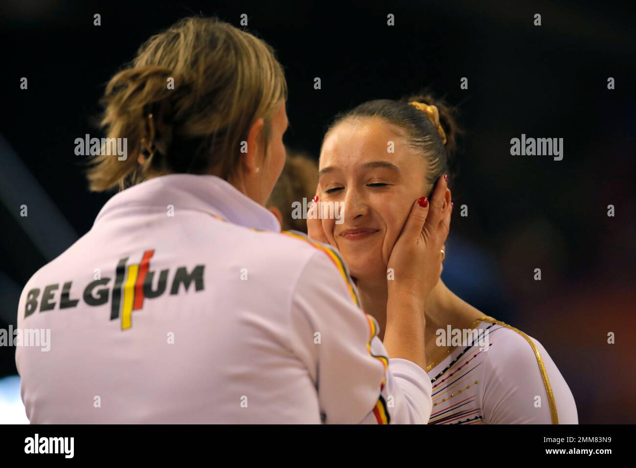 Coach Marjorie Heuls hugs gold medallist Belgium's Nina Derwael, right ...