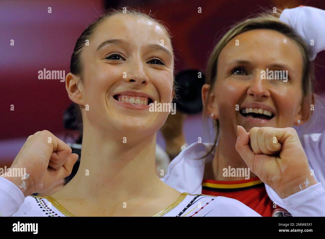 Gold medallist Belgium's Nina Derwael celebrates with her coach ...