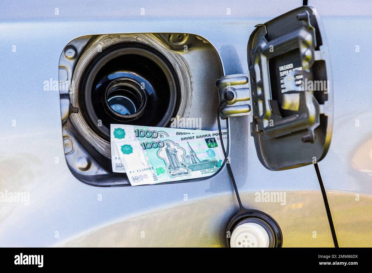Russian roubles banknotes in the gas tank of a vehicle. Concept photo ...