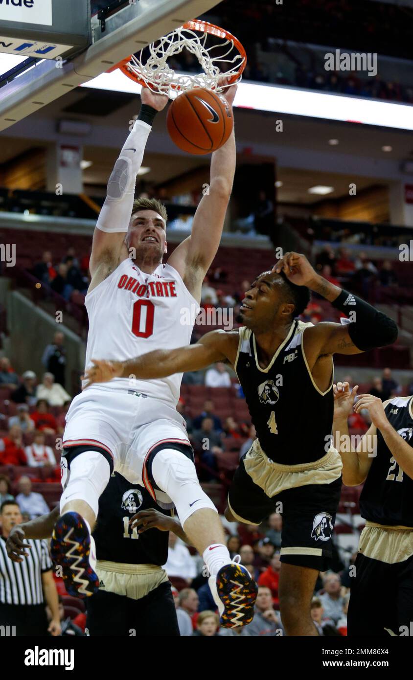 Ohio State center Micah Potter, left, dunks the ball against UNC ...