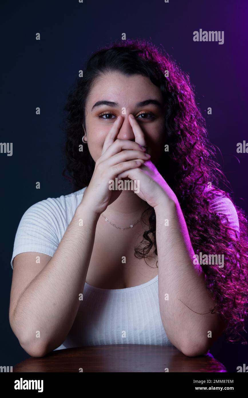 Young beautiful woman with both hands on her lower face. Isolated ...